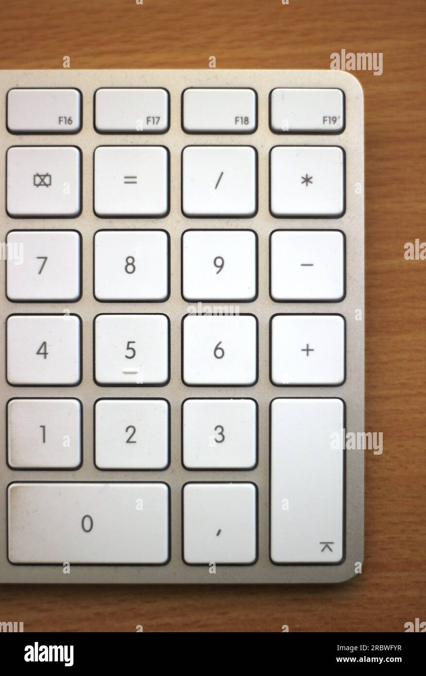 Numpad of an Apple keyboard on wooden desk Stock Photo - Alamy