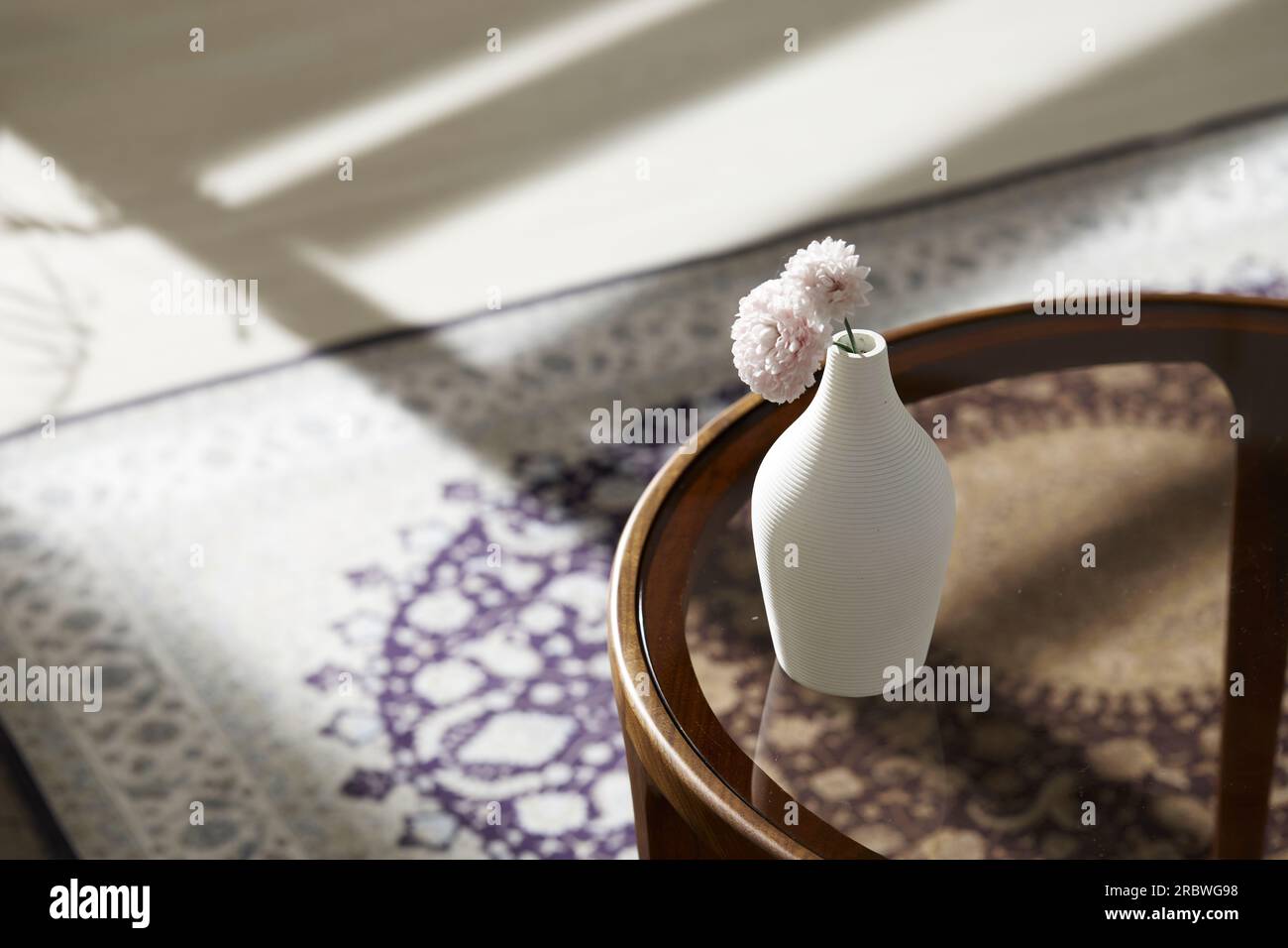 Vases and objects on the table in a warm room with sunlight coming in ...