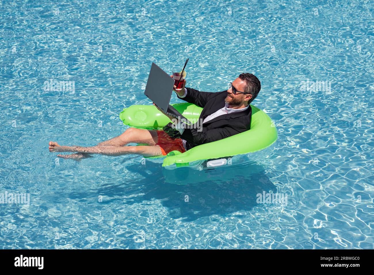Handsome man floating in pool hi-res stock photography and images - Alamy