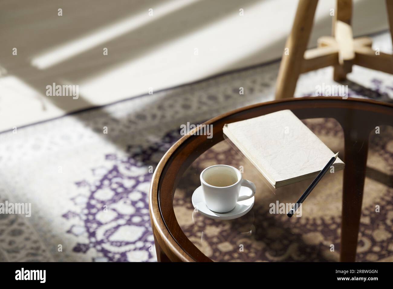 Vases and objects on the table in a warm room with sunlight coming in ...