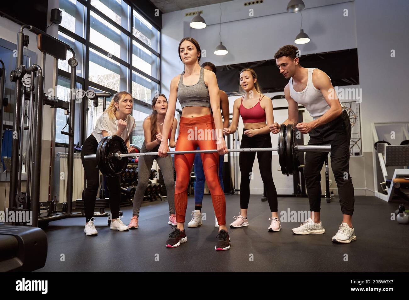 Supportive Group of Friends Encouraging and Cheering On a Woman as She ...