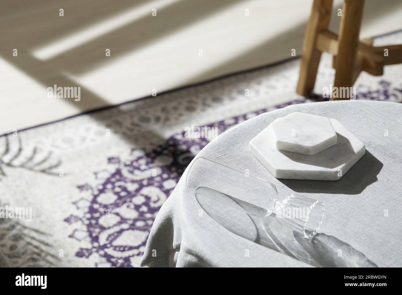 Vases and objects on the table in a warm room with sunlight coming in ...