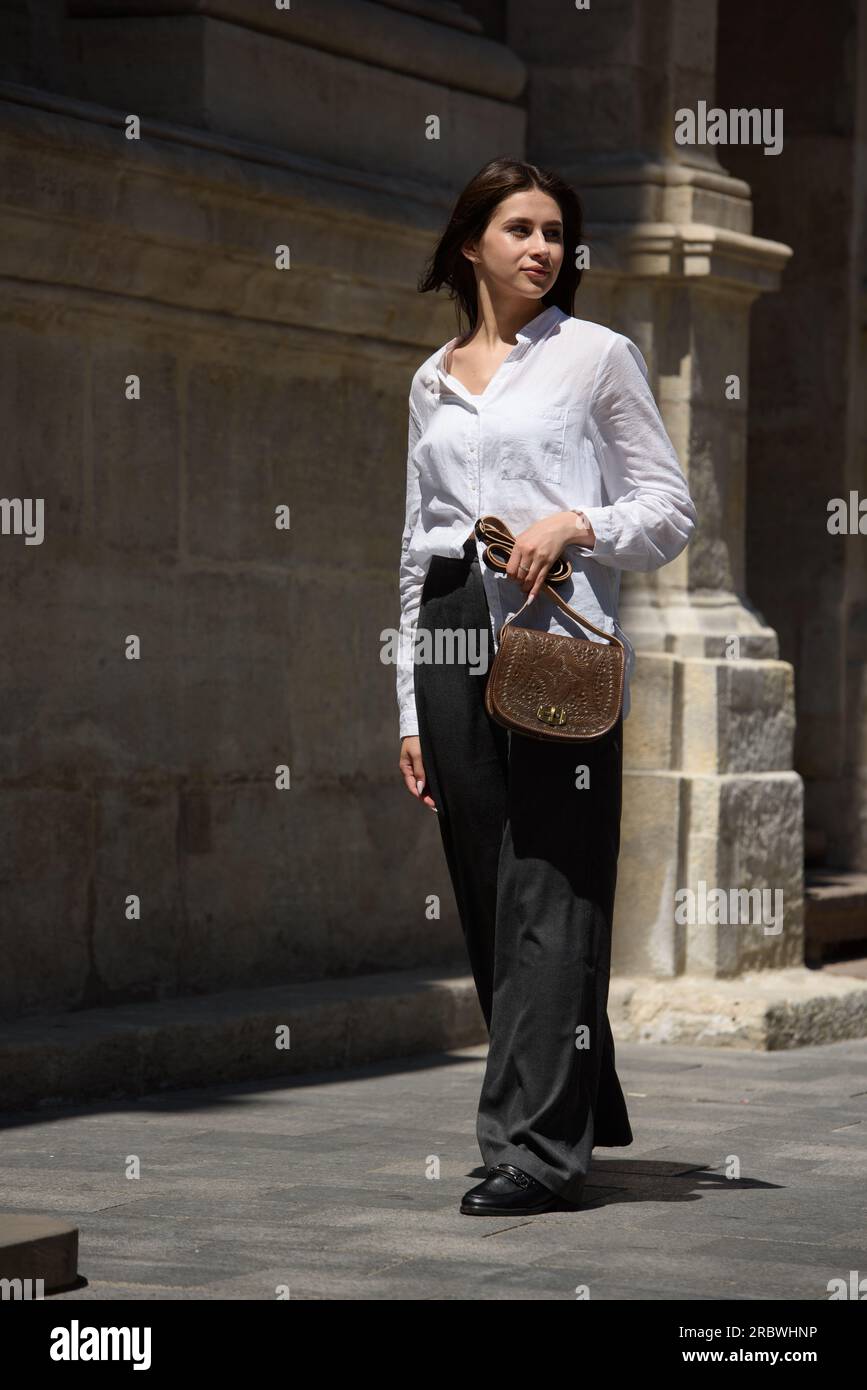 Street photo of young beautiful woman wearing stylish classic clothes ...
