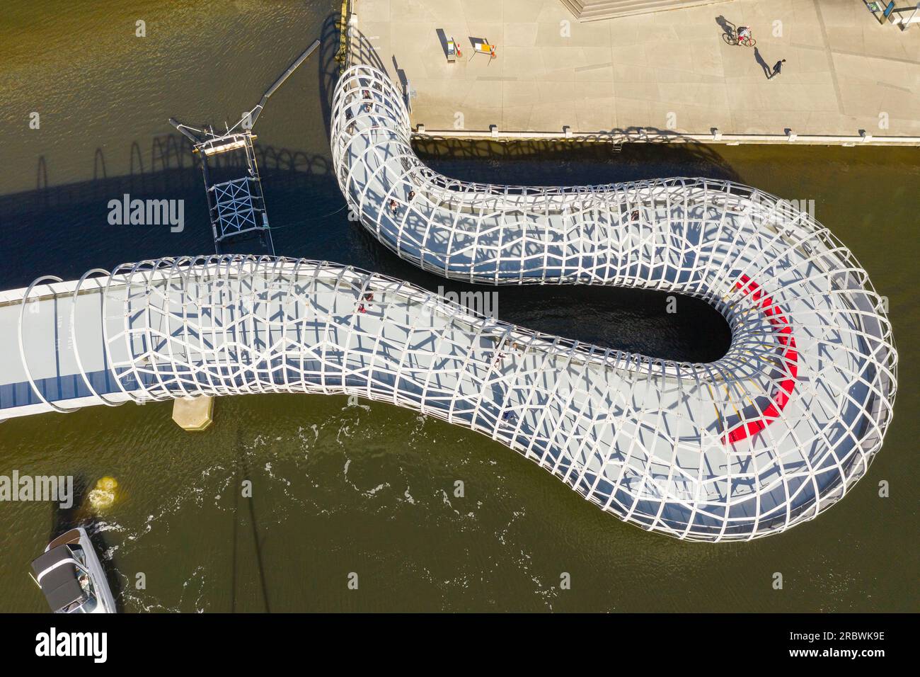 Aerial view of a modern foot bridge with metal sculptured exterior over ...