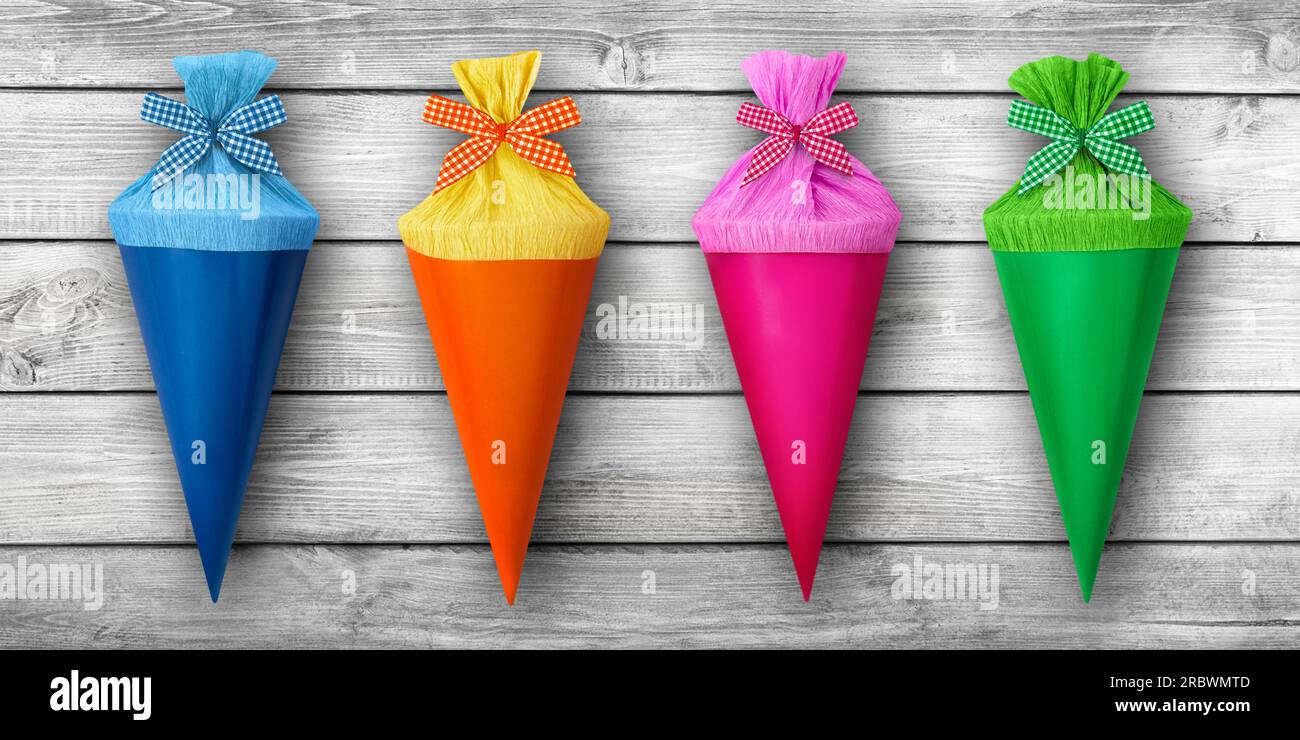 4 Cornets and presents with ribbon against wooden background Stock ...
