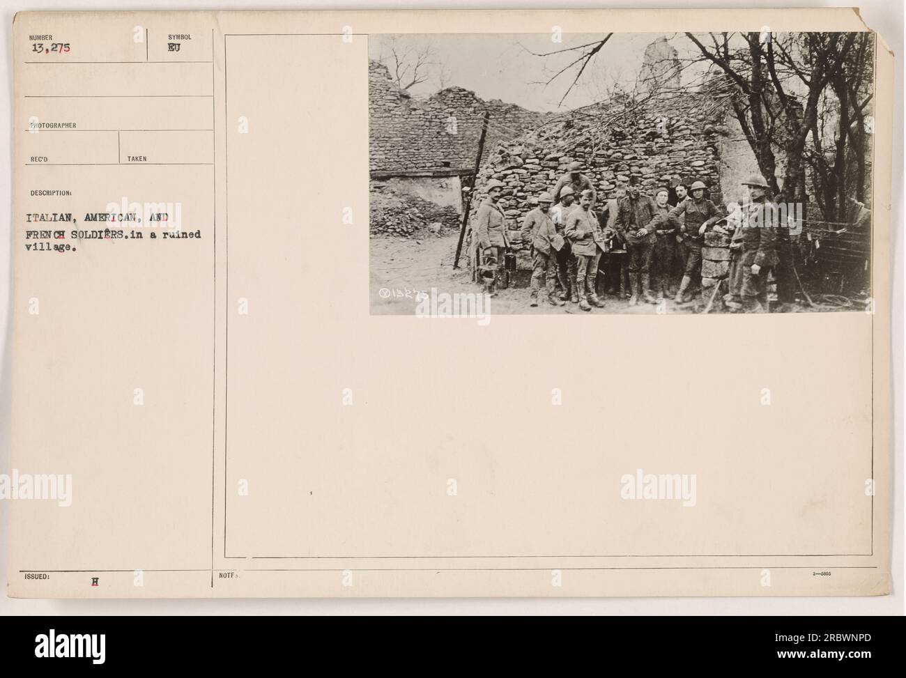Italian, American, and French soldiers stationed in a ravaged village ...