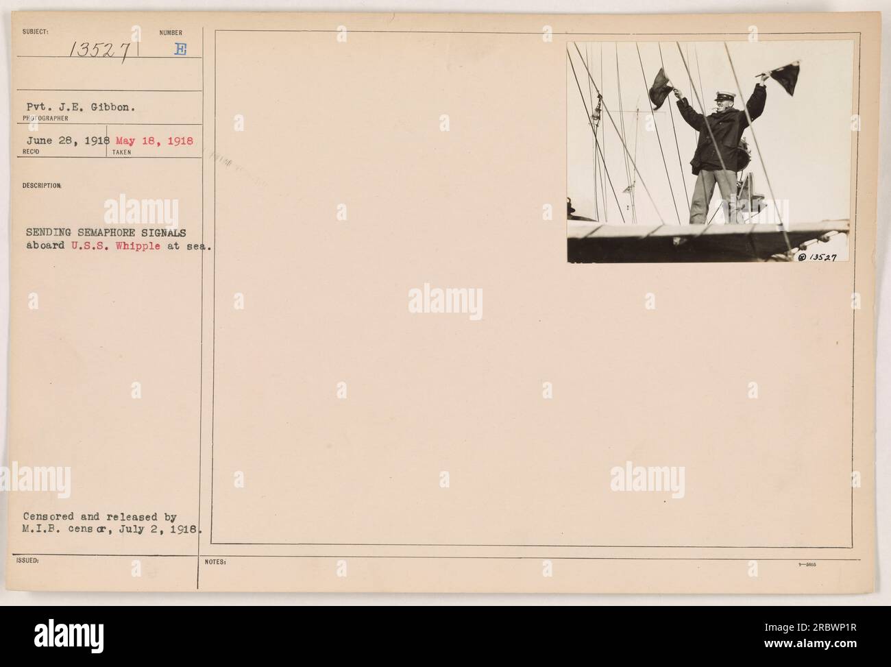 Private J.E. Gibbon sending semaphore signals aboard the U.S.S. Whipple ...