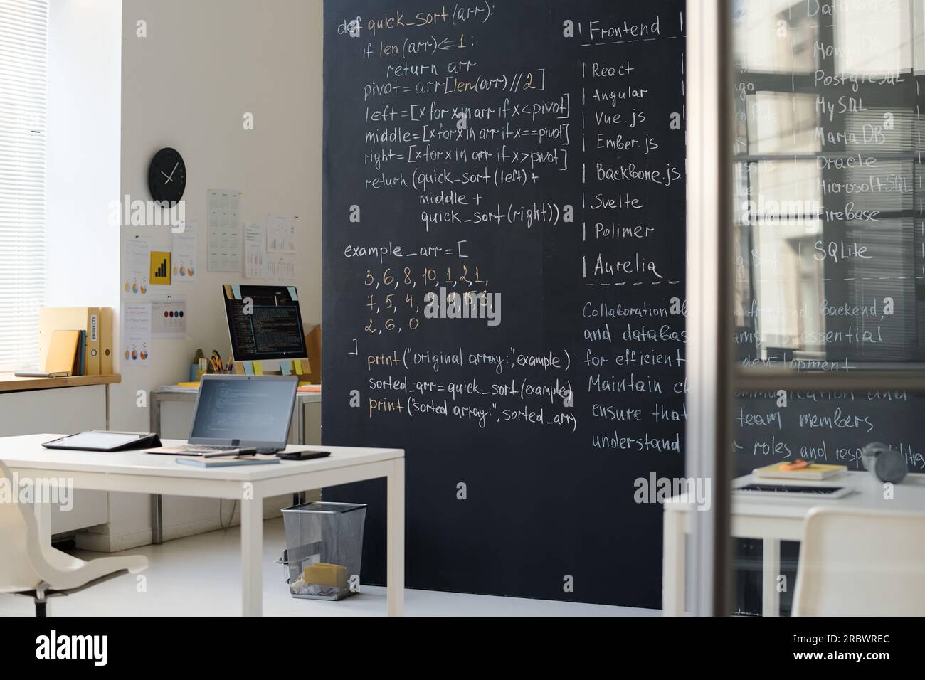 Modern empty IT class with formulas on blackboard and codes on ...