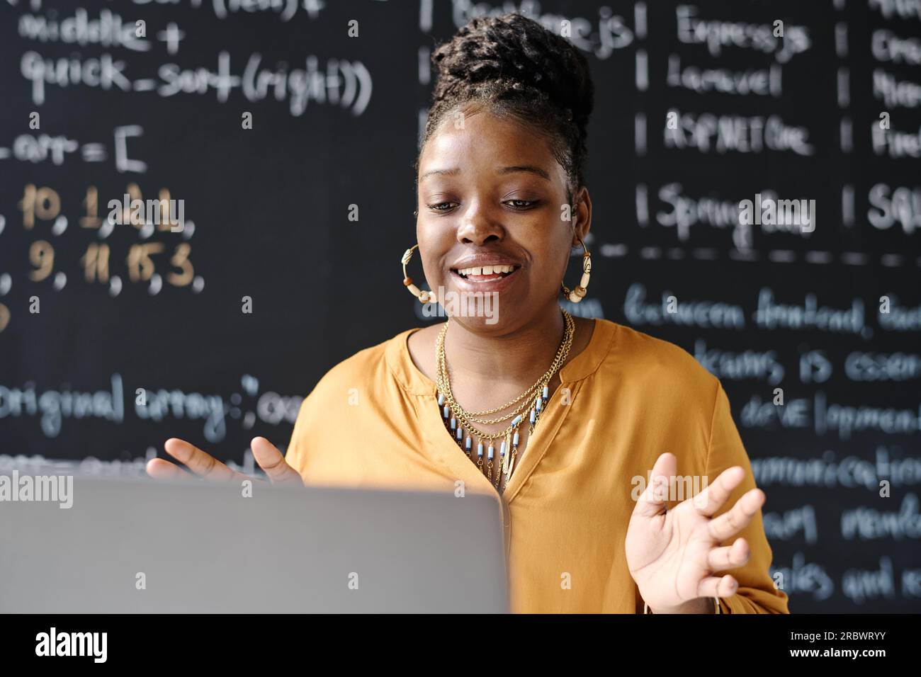 African American student sitting in front of laptop and having video ...