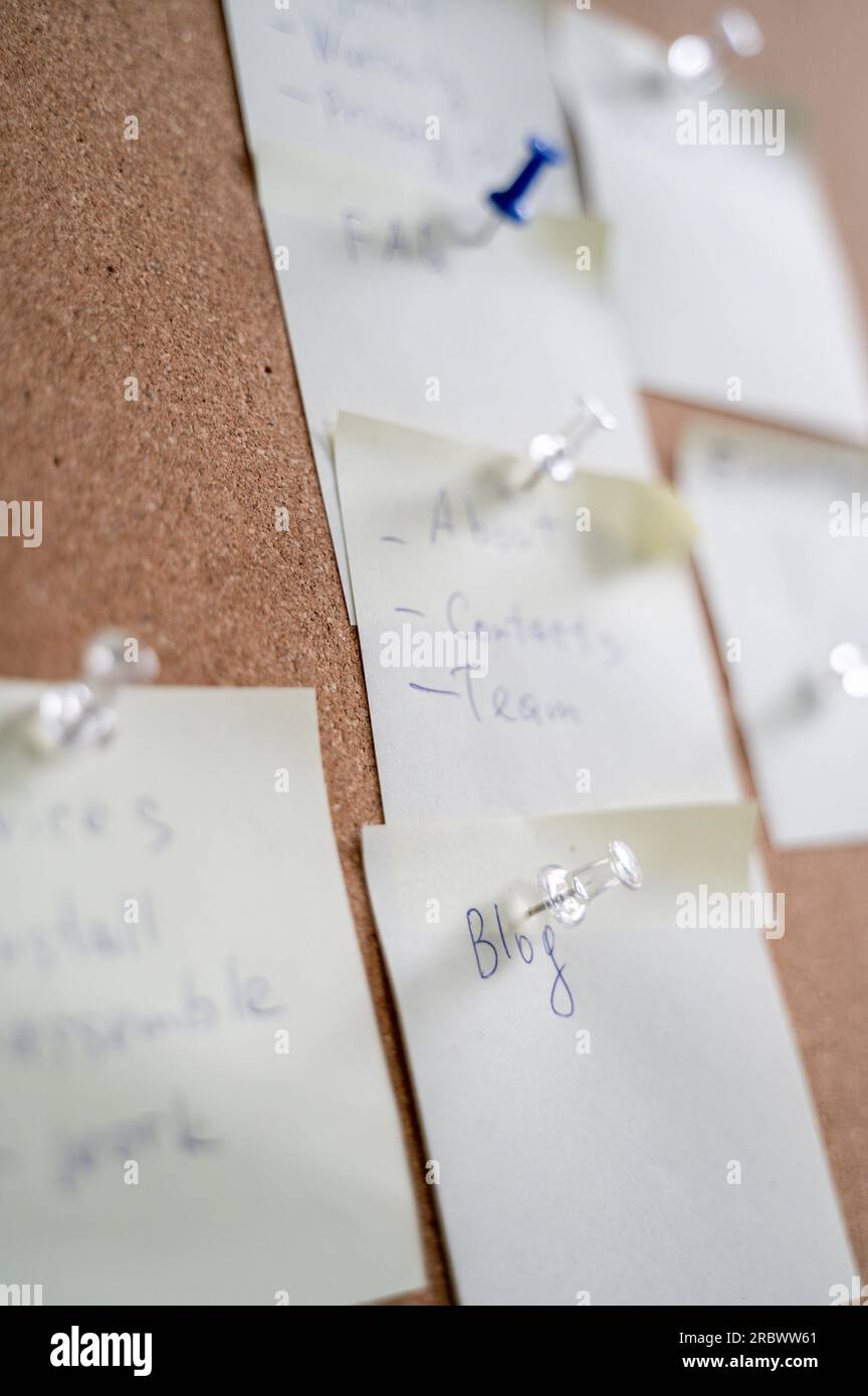 A lot of memos on cork bulletin board with pins. Tasks planning ...