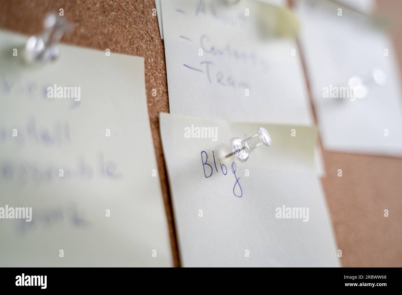 A lot of memos on cork bulletin board with pins. Tasks planning ...