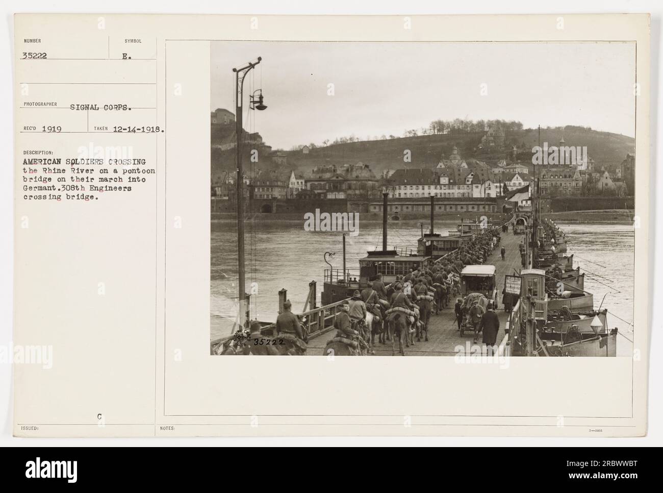 American soldiers crossing the Rhine River on a pontoon bridge as they ...