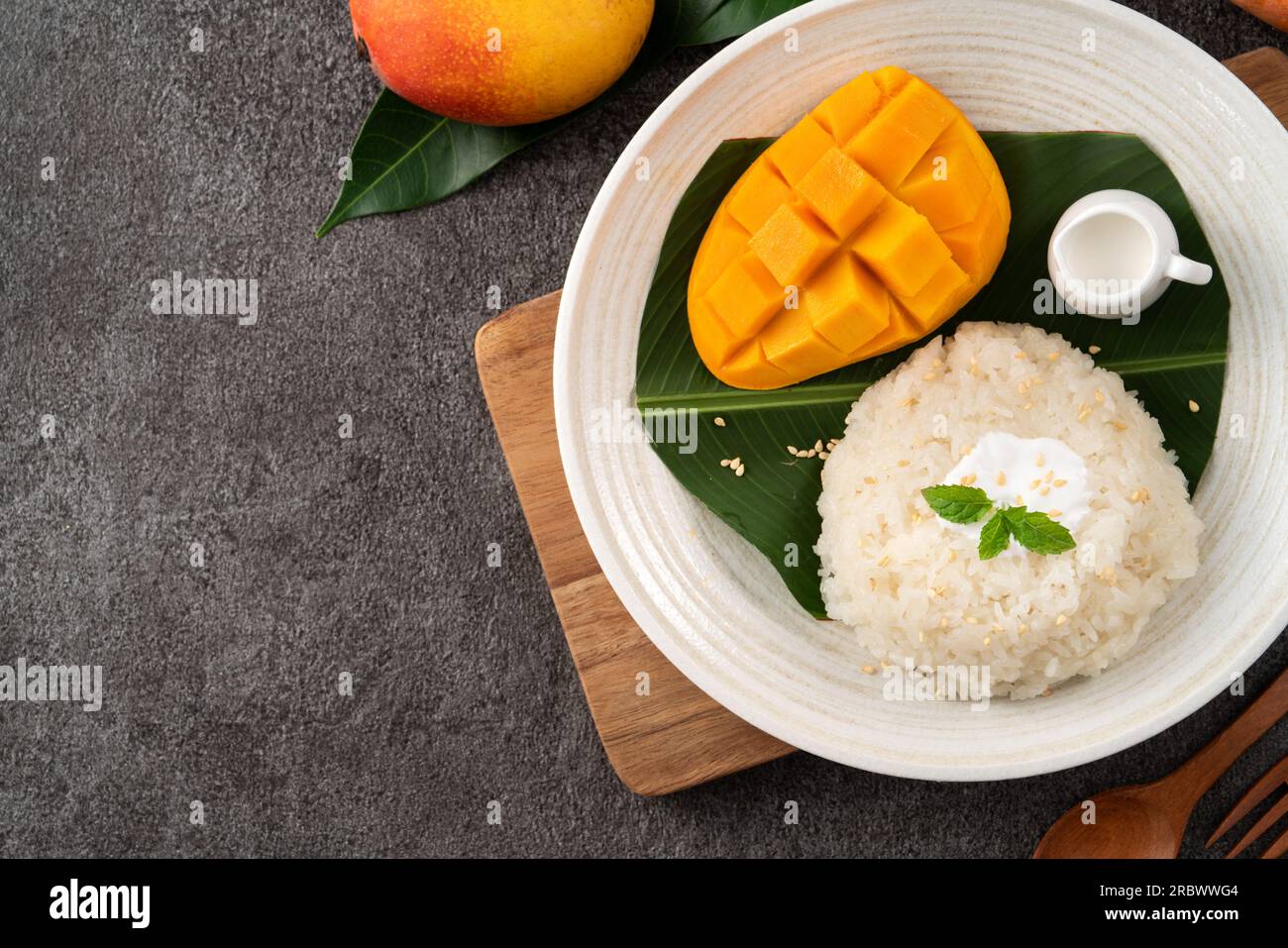 Delicious Thai mango sticky rice with cut fresh mango fruit in a plate ...