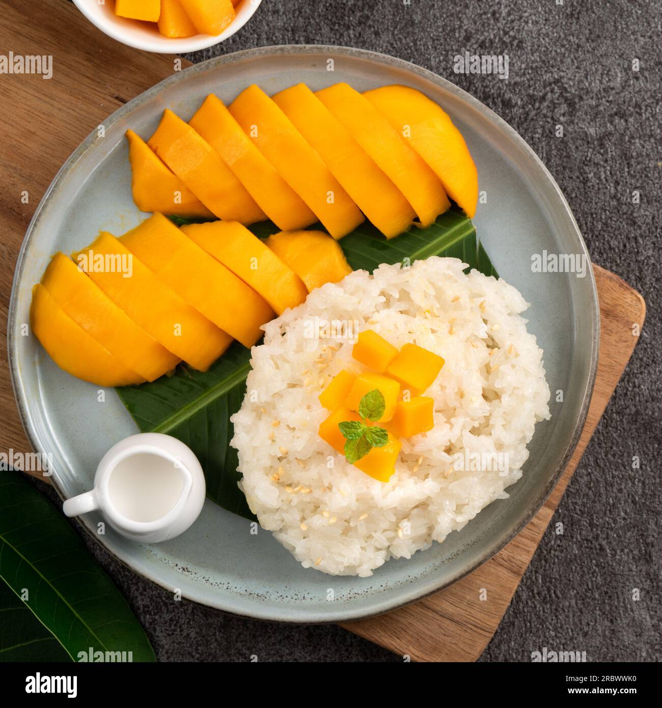 Delicious Thai mango sticky rice with cut fresh mango fruit in a plate ...