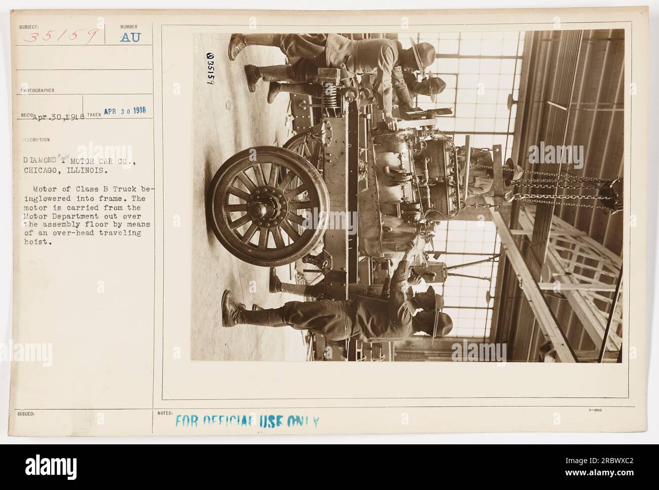 A motor of a Class B truck being lowered into its frame at the Diamond ...