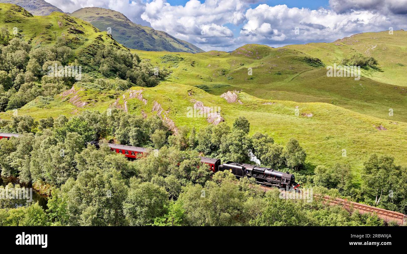 Jacobite Steam Train en route through the green hills and mountains ...