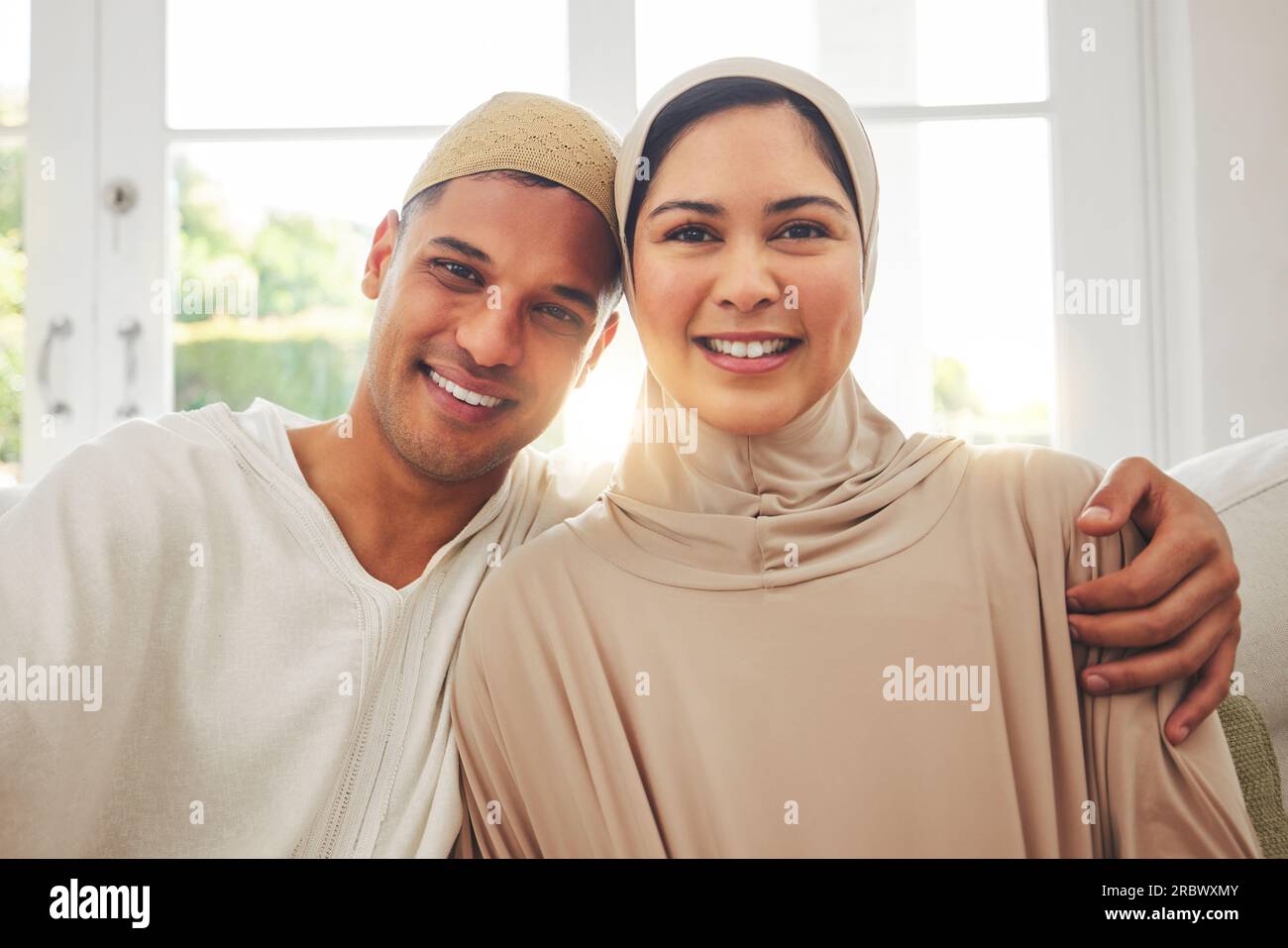 Portrait, Islam and happy couple on couch for Eid with smile, culture ...