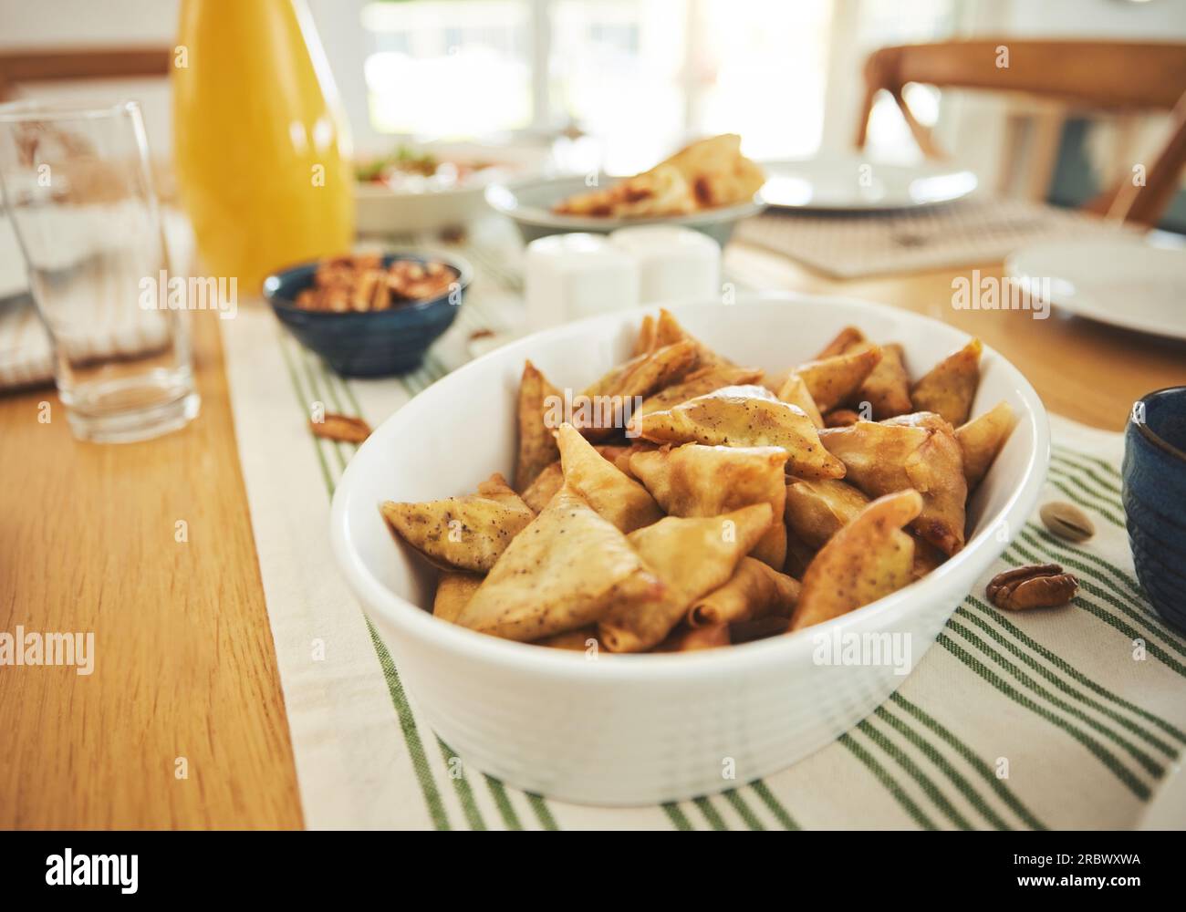 Food, Eid Mubarak and samosa for family at table for Islamic ...
