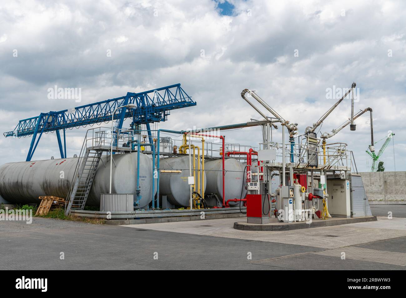 Large industrial filling station with big fuel tanks and overhead crane ...