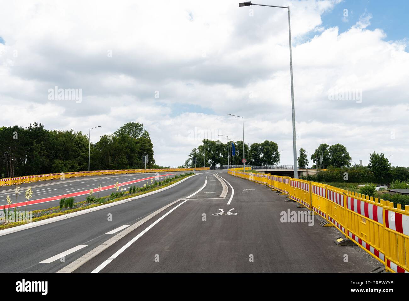 The new road leading to the bridge is fenced off with bright yellow ...