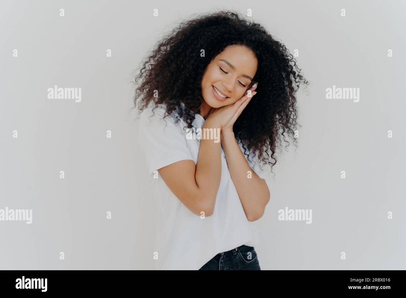 Woman tilts head gentle smile hi-res stock photography and images - Alamy