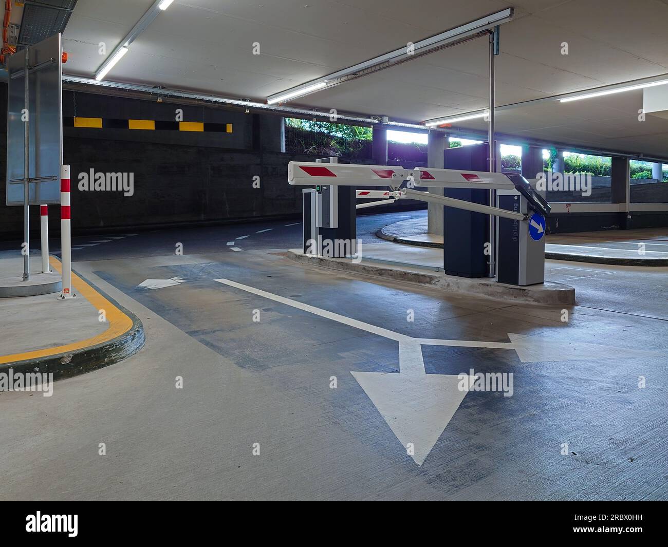 Underground large car park entrance and exit lanes with ticket ...