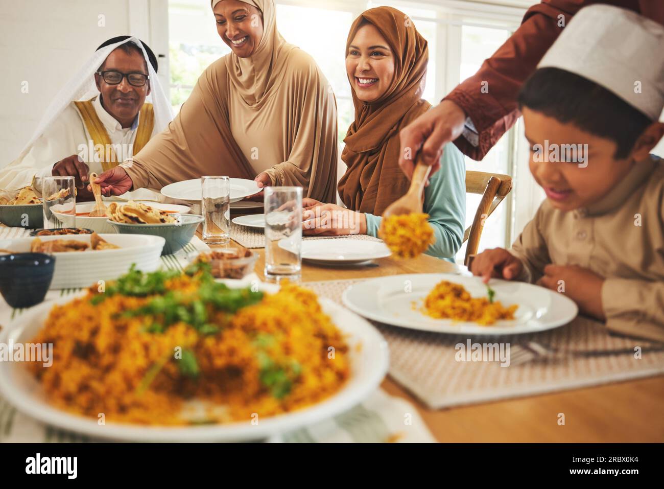Food, islam and muslim with big family at table for eid mubarak ...