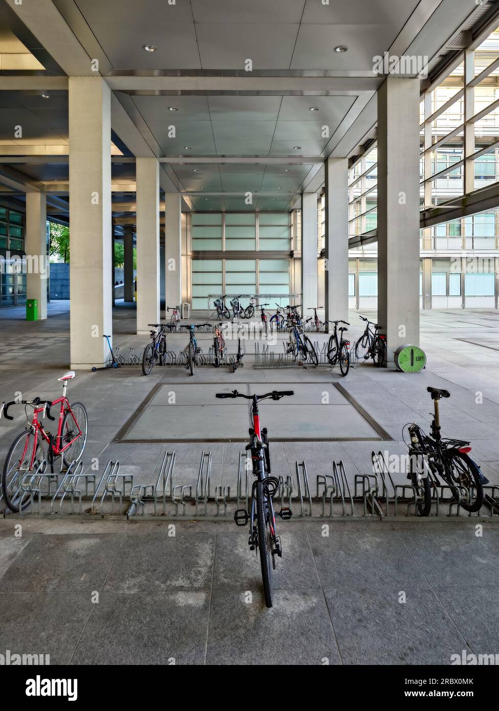 University campus bicycle parking racks next to modern architecture ...