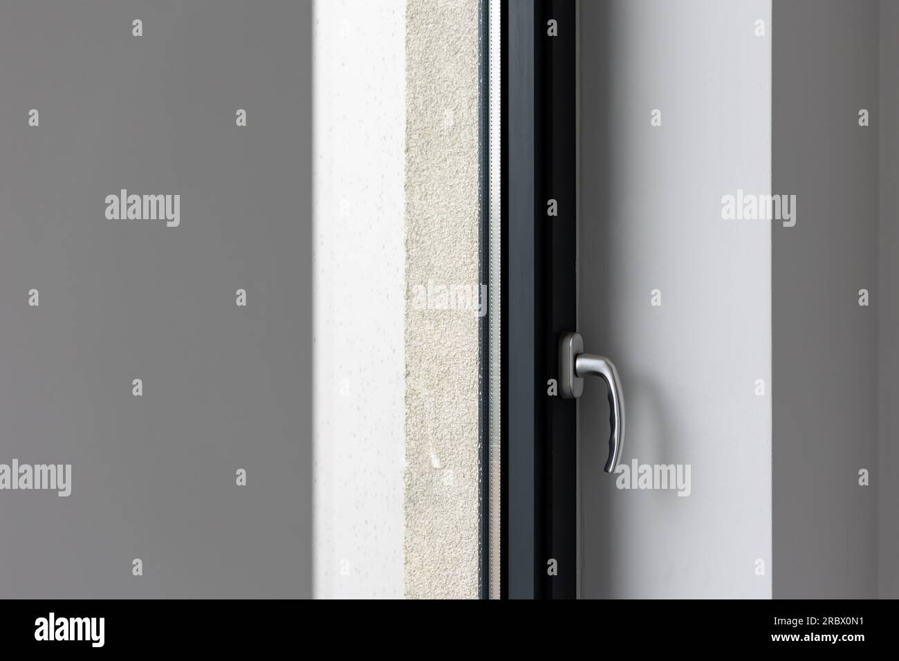 Tilt and turn window handle in a large window in a public building. The ...