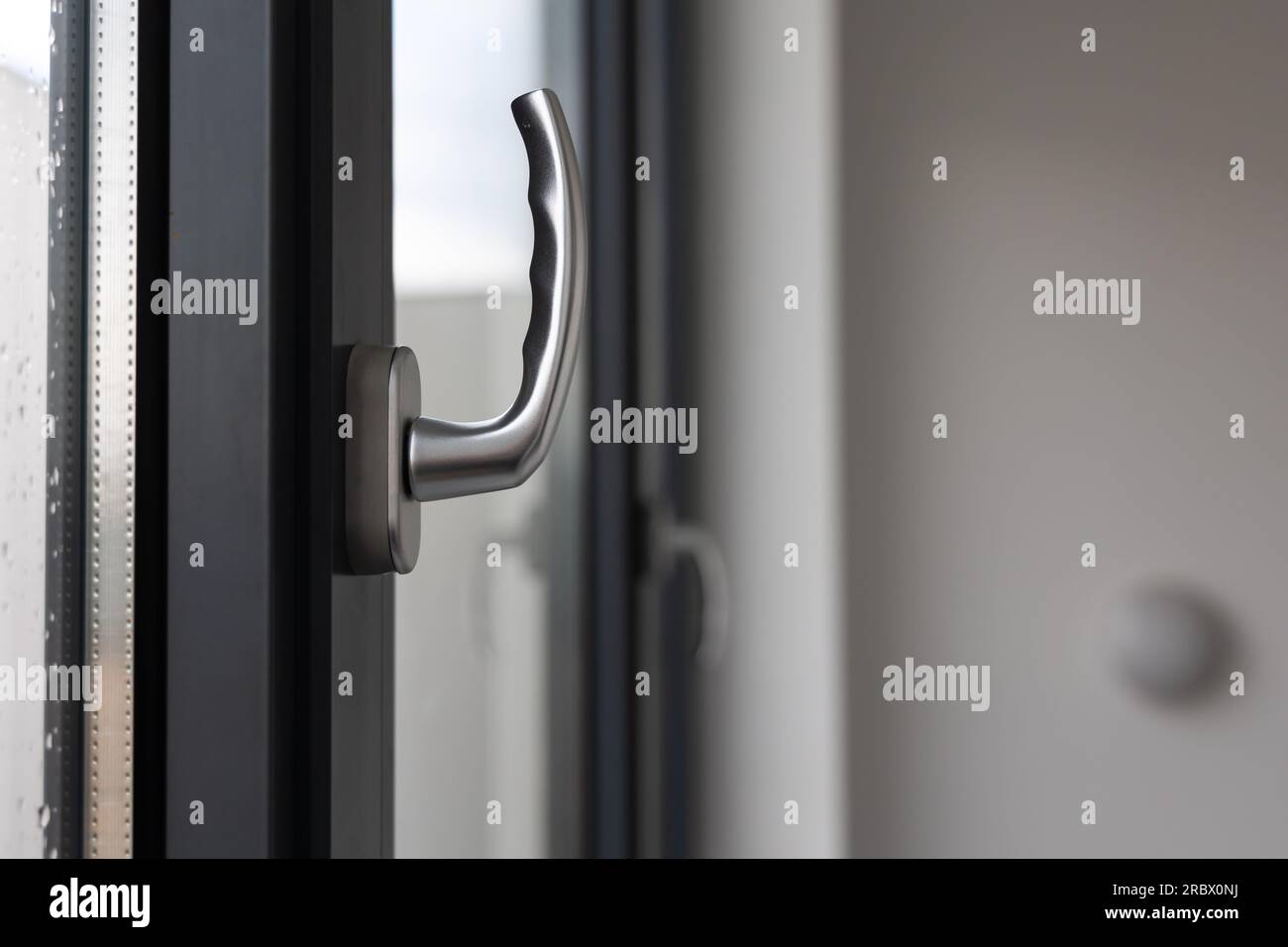 Tilt and turn window handle in a large window in a public building. The ...