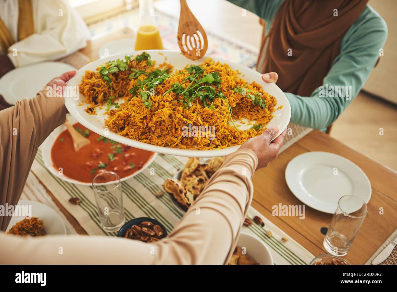 Culture, Eid Mubarak and food for family at table for Islamic ...