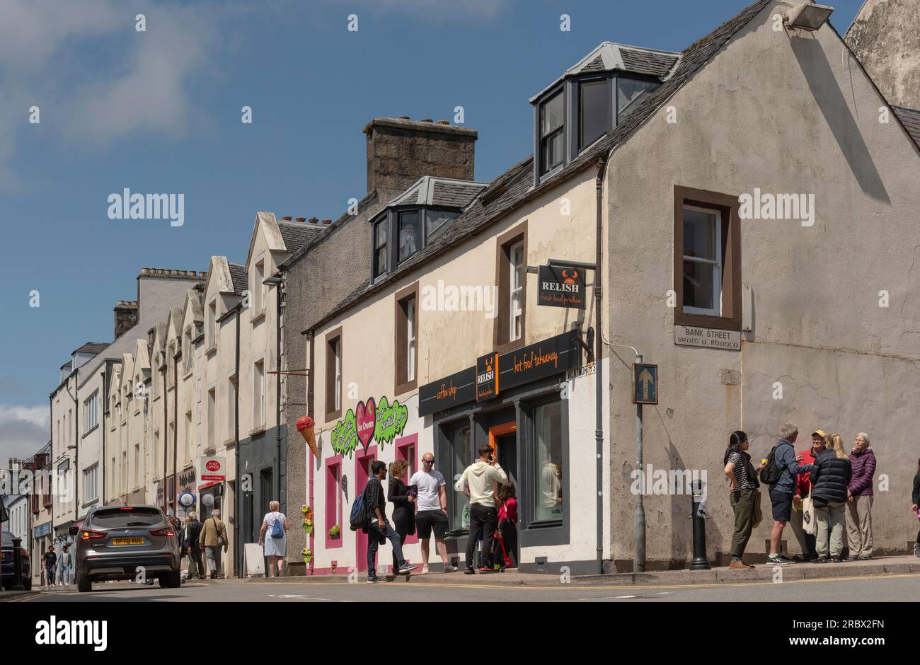 Portree, Isle of Skye, Scotland, UK. 5 June 2023. People queueing outside a coffee shop in the ...