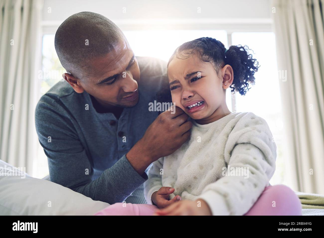 Father, crying girl kid and comfort with talk, care and support with ...
