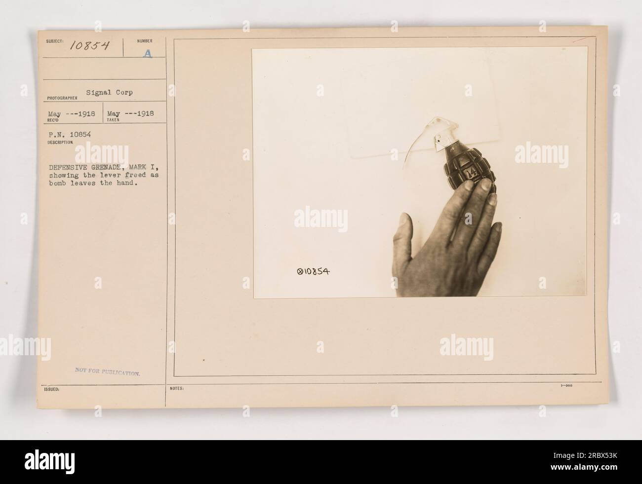 Image shows a close-up of a defensive grenade, Mark I, with the lever ...