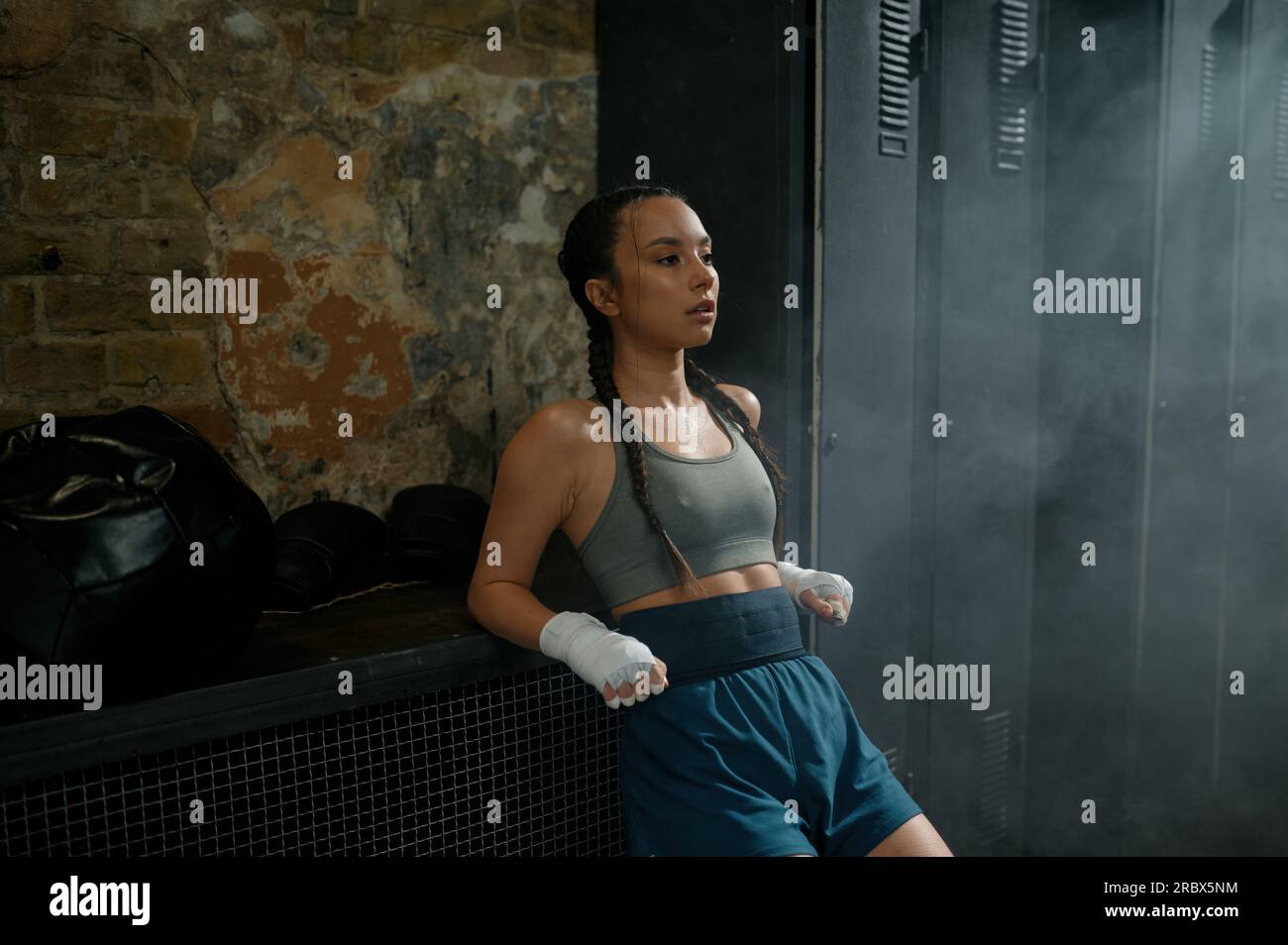 Athletic young woman boxer feeling tired and energy loss after hard ...