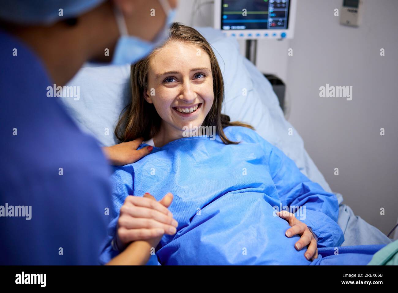 Pregnant woman, labor and hospital with holding hands, bed and support ... Pregnant woman, labor and hospital with holding hands, bed and support ...