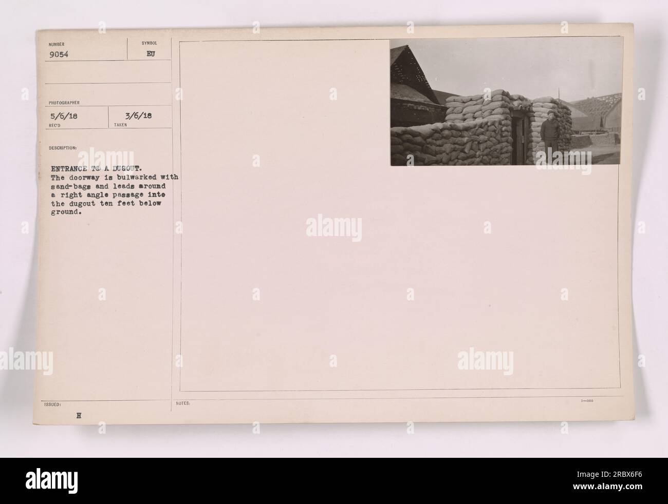 American soldiers enter a dugout during World War One. The entrance is ...