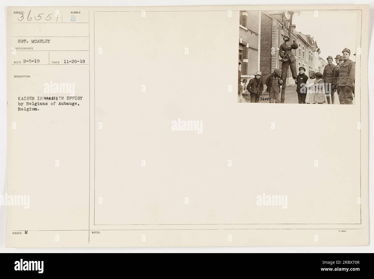 Image ID: 111-SC-36551 Caption: Belgians in Aubauge, Belgium, hang an ...