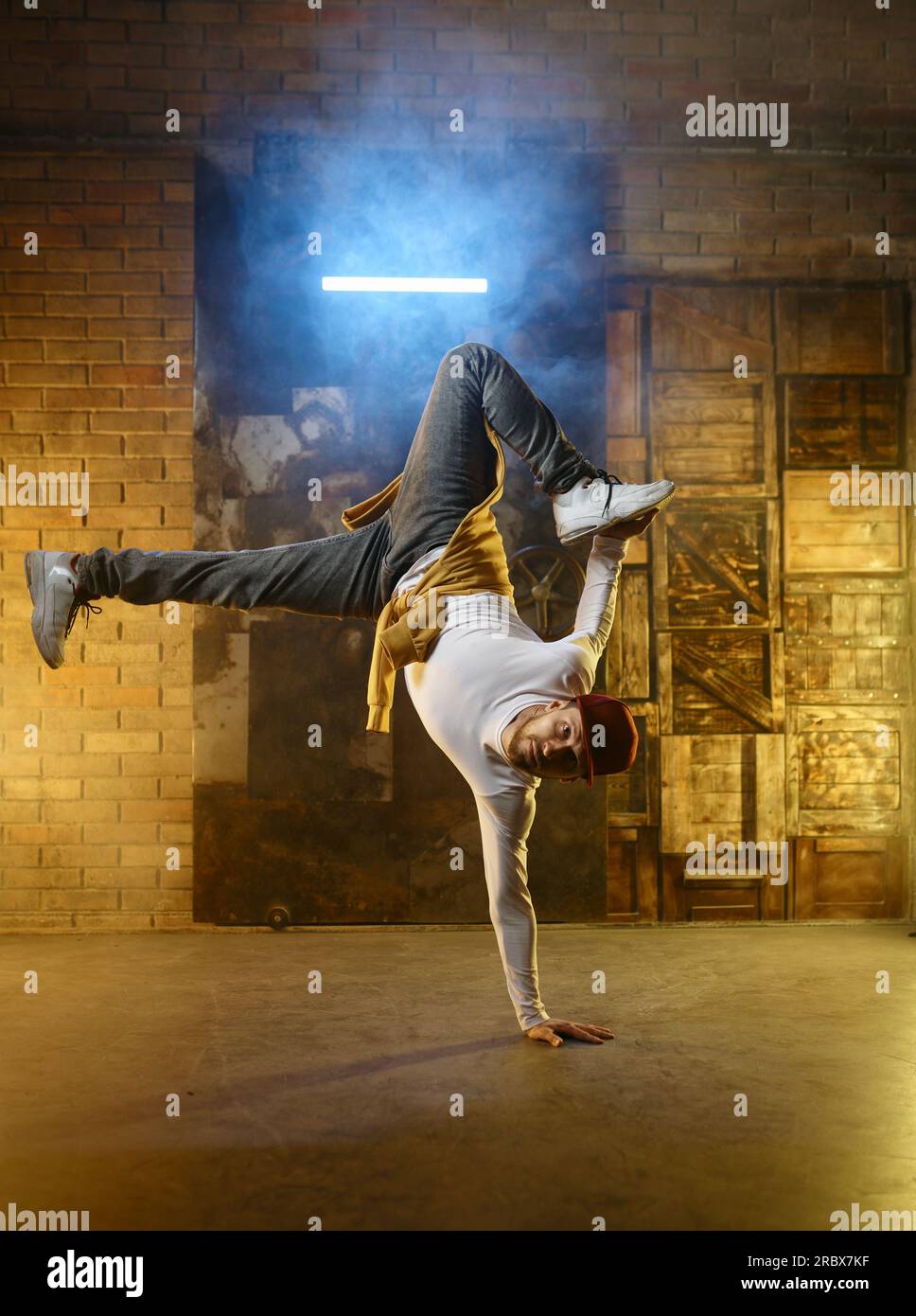 Handsome young man developing freeze over dance studio background Stock ...