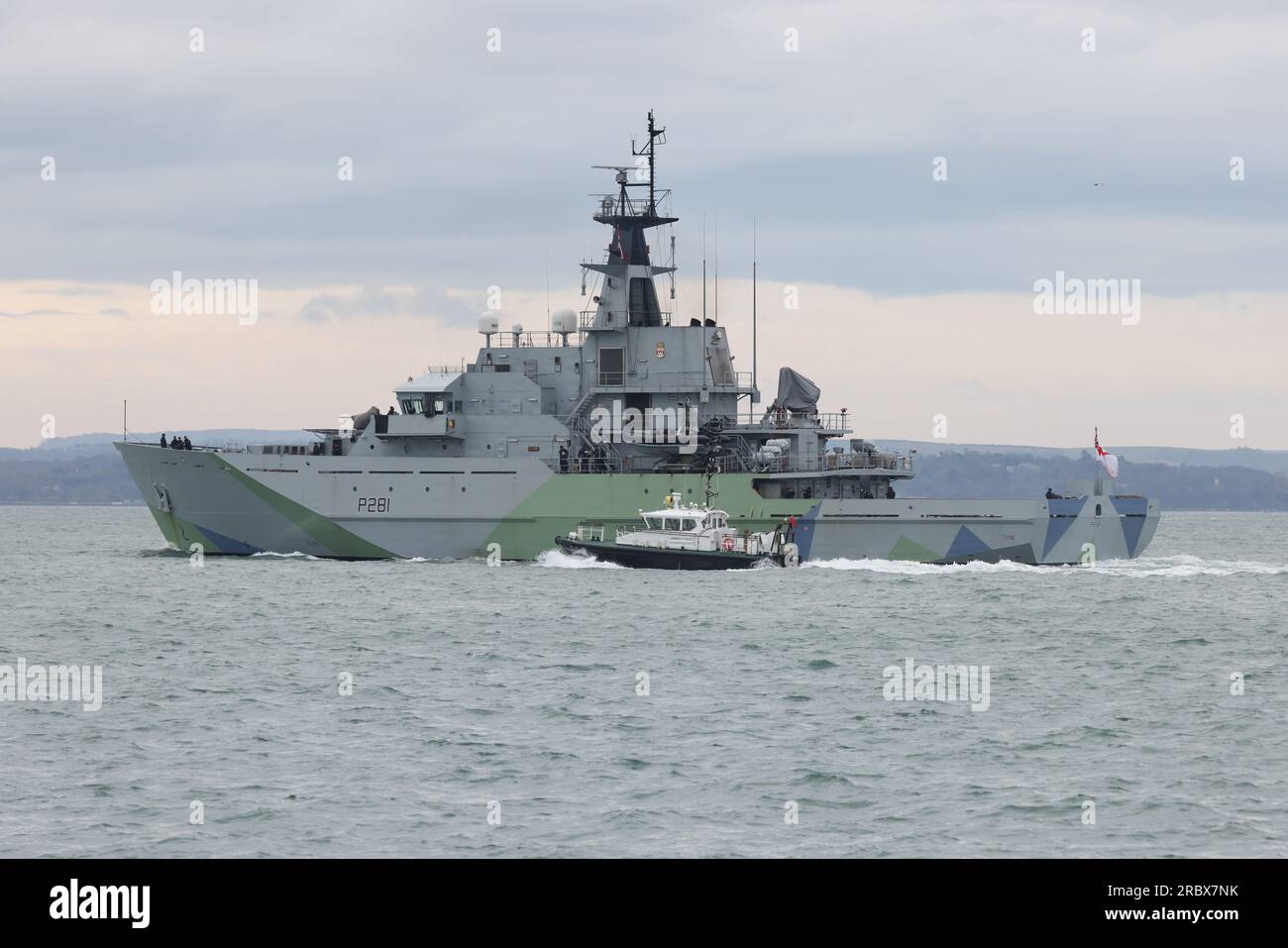 A launch stays close to the side of the Royal Navy River class offshore ...