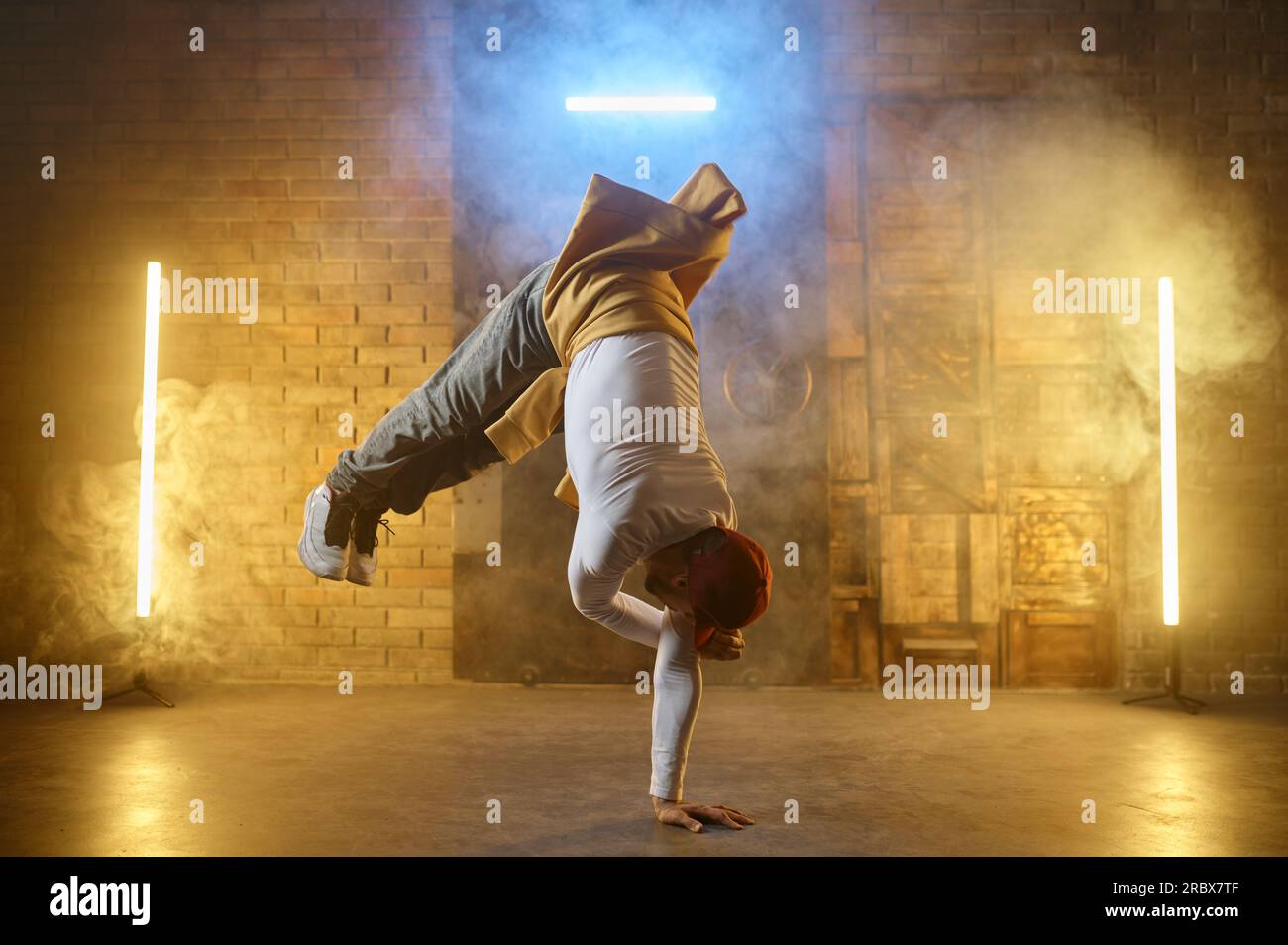 Male street artist b-boying performing breakdancing active training ...