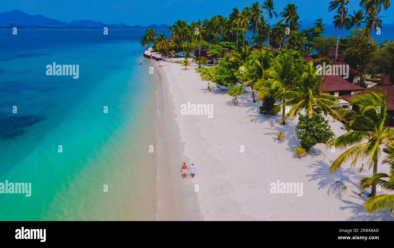 A couple of men and women on vacation at Koh Mook tropical Island in ...