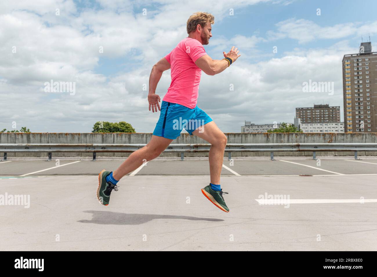 Fit man running, urban background Stock Photo - Alamy