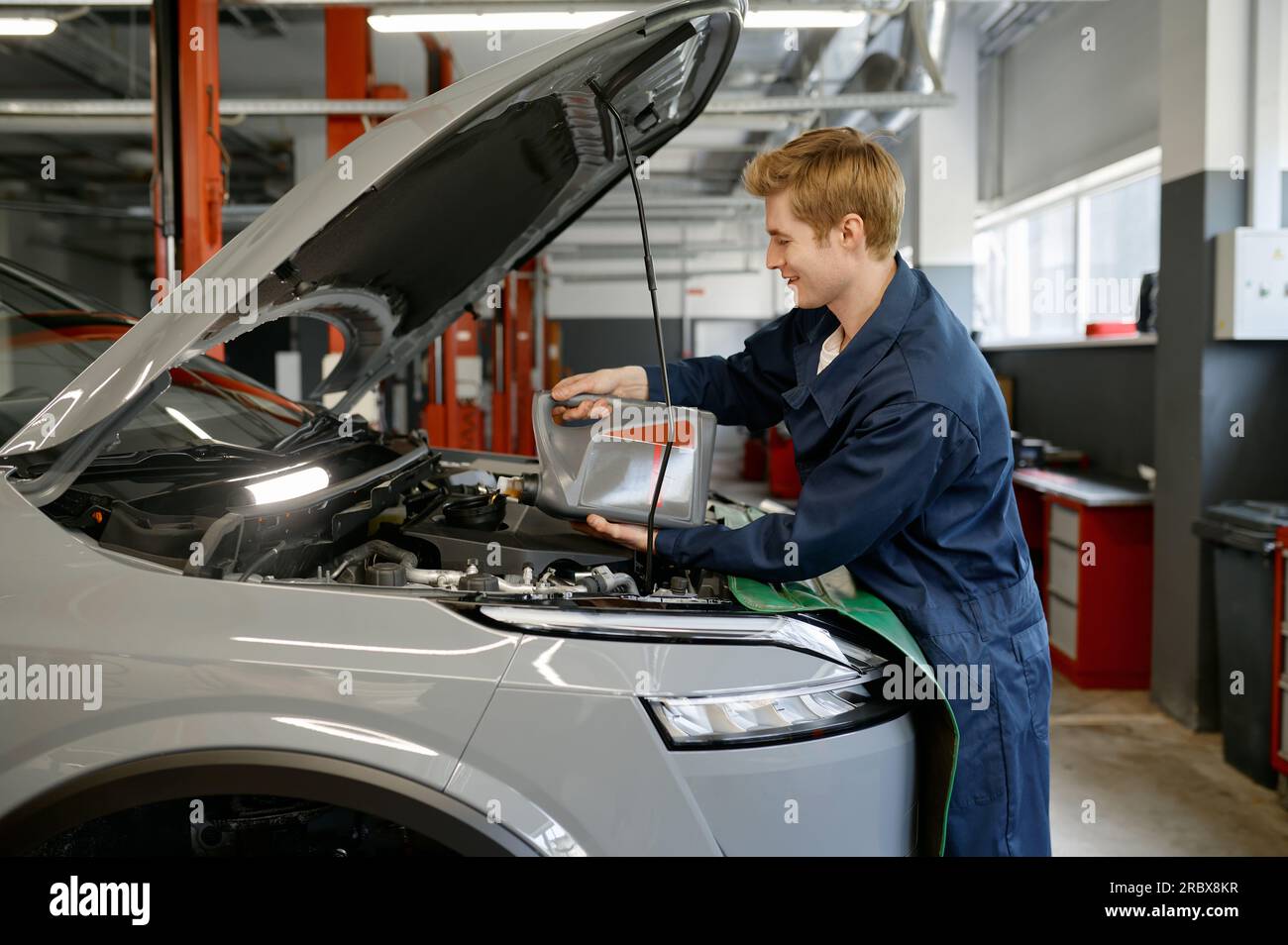 Technician pouring fresh motor hi-res stock photography and images - Alamy