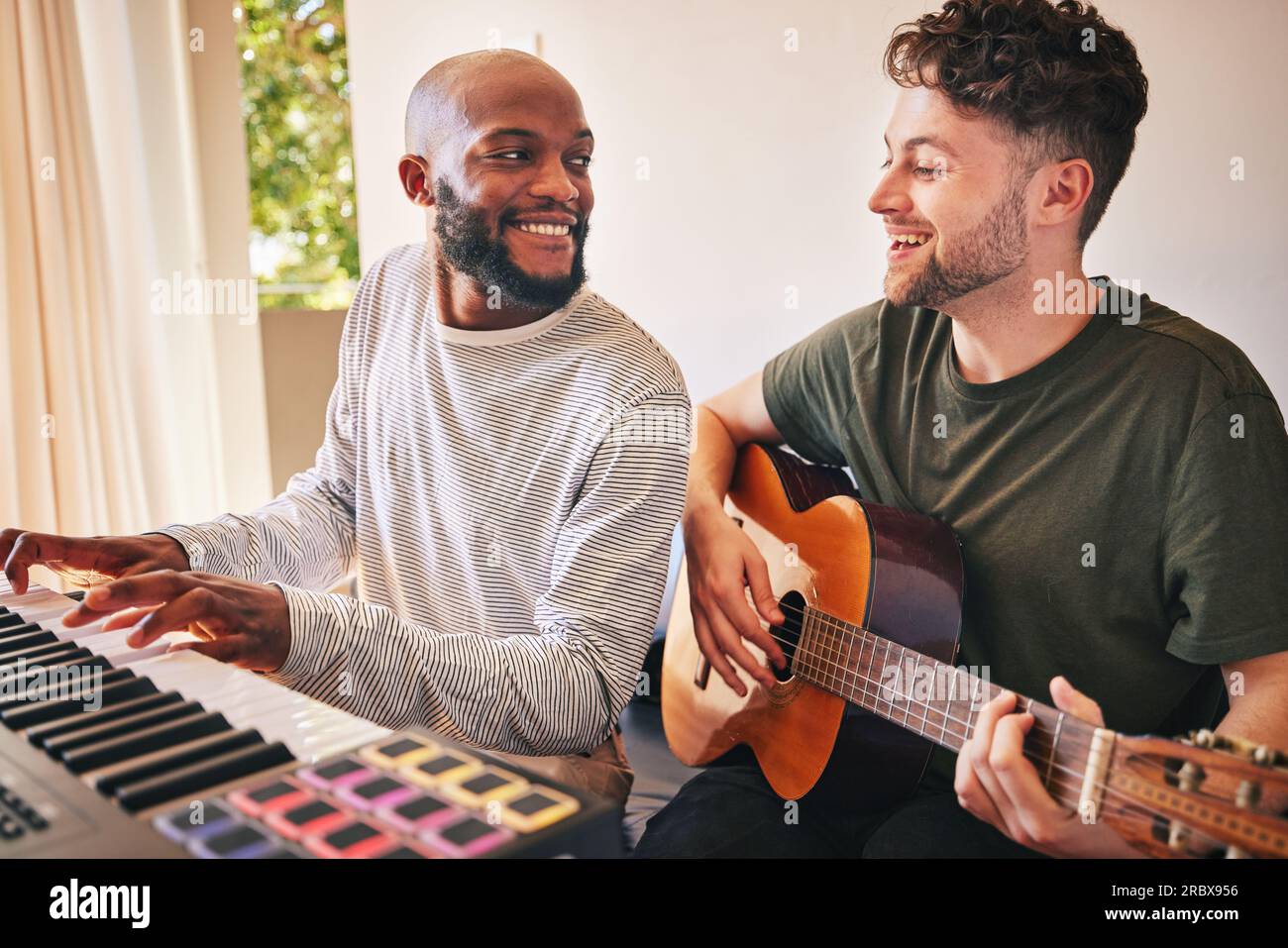 Friends, band and smile with piano, guitar and song production in home ...