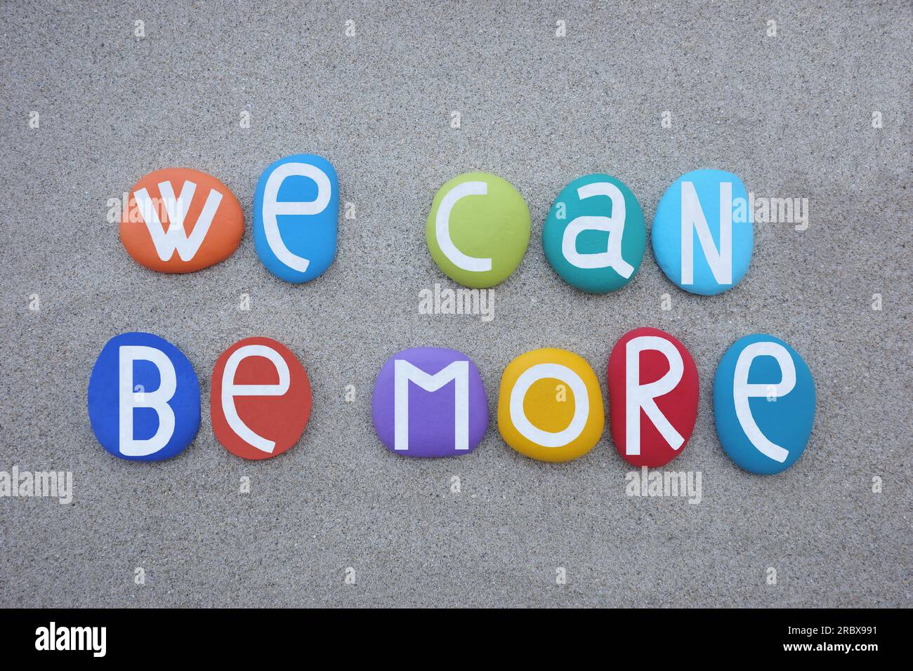 We can be more, motivational slogan composed with multi colored stone ...