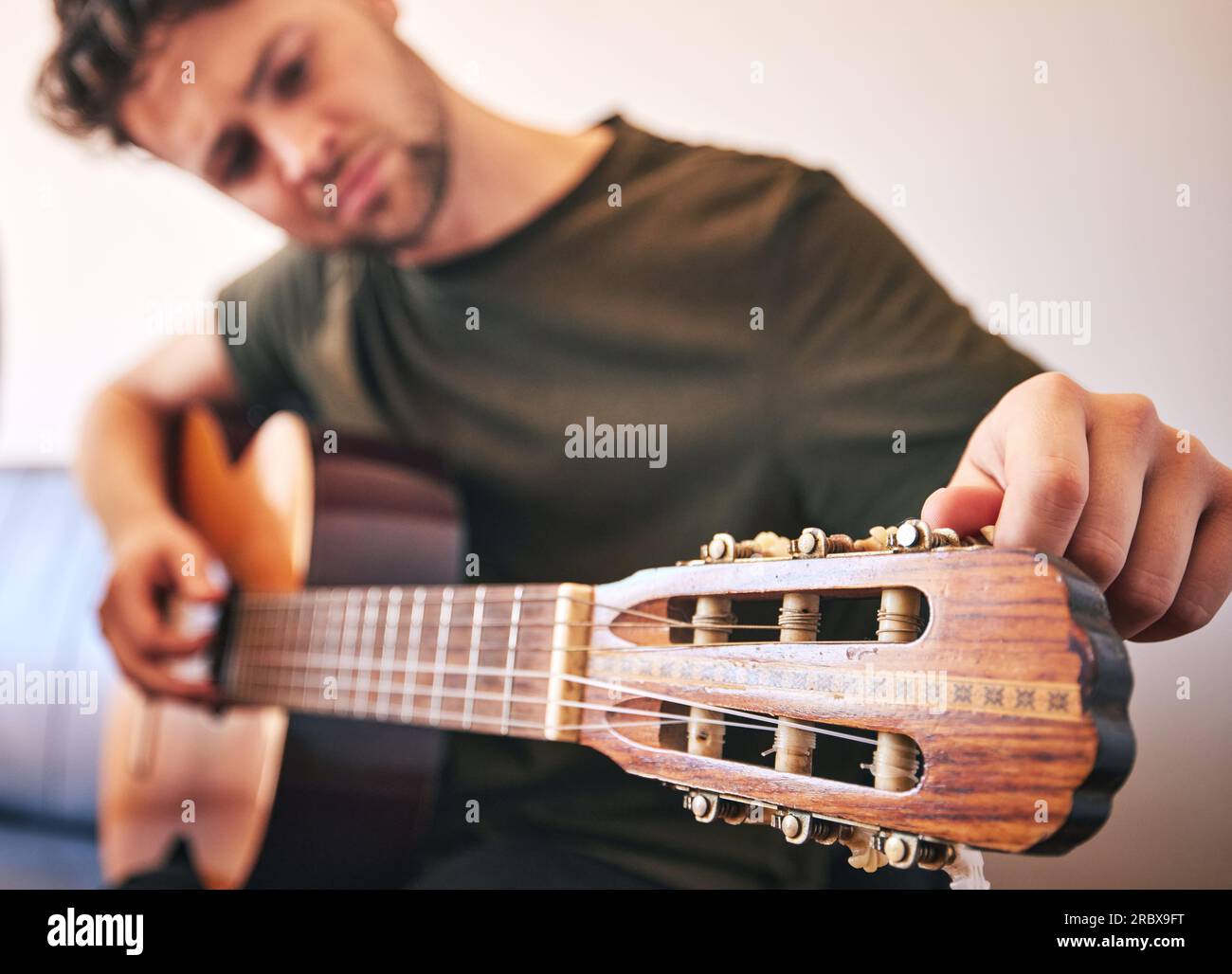 Closeup, man and tuning guitar for music, talent and creative skill of ...