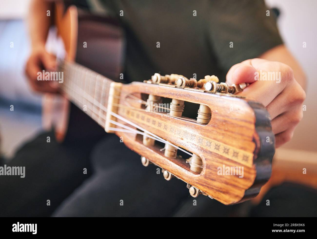 Hands, person and tuning guitar for music, talent and creative skill in ...