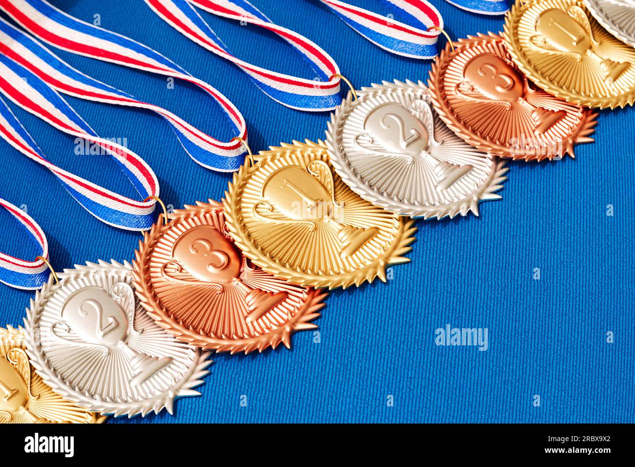 Collection of gold, silver, and bronze medals with colorful ribbons ...