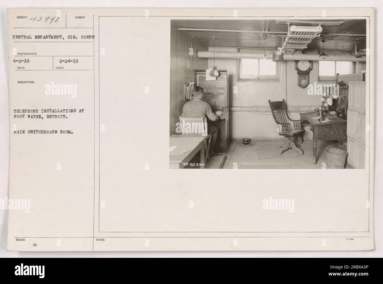 This photograph depicts the main switchboard room of the telephone ...